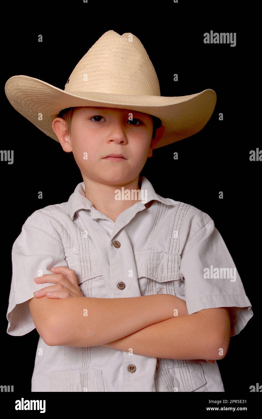 Young boy wearing a cowboy hat isolated on black Stock Photo - Alamy