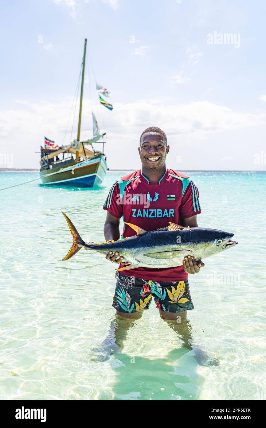 Portrait of happy fisherman showing the catch of fish, Zanzibar ...