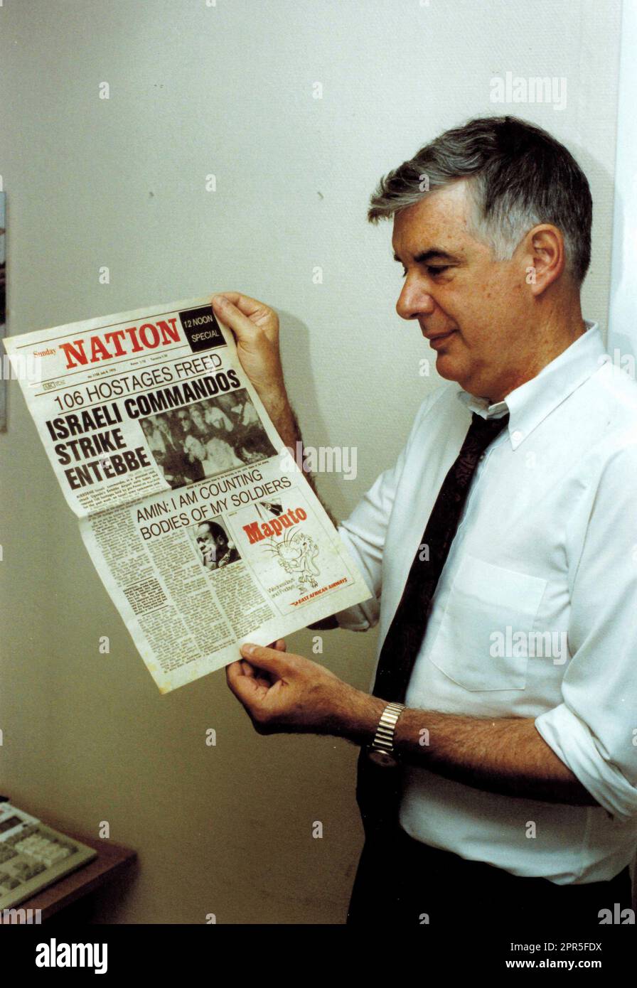 Associated Press correspondent Andrew Torchia holds the front page of a ...