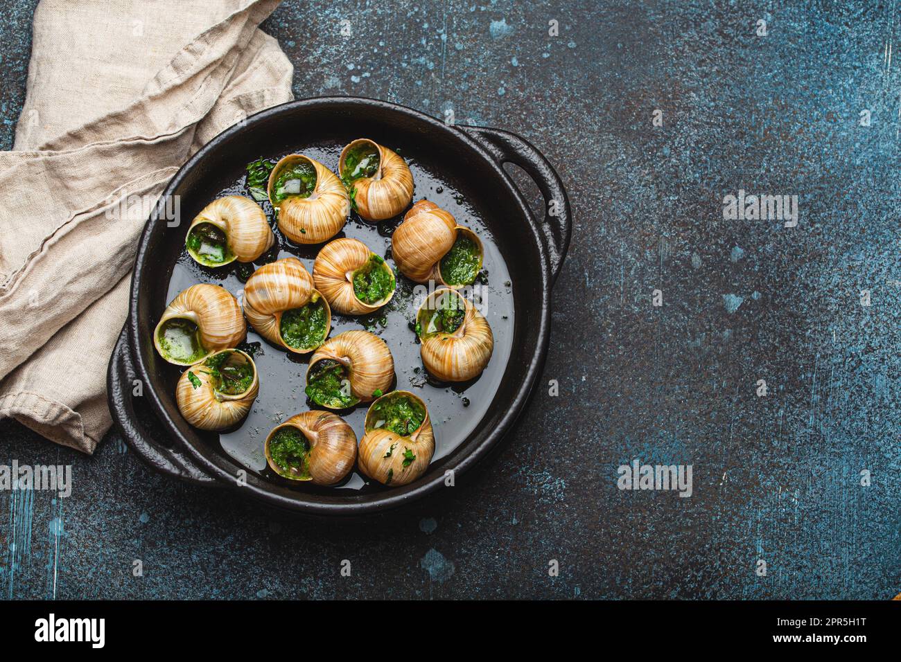 Escargots de Bourgogne Snails with Garlic Butter and Parsley in black ...