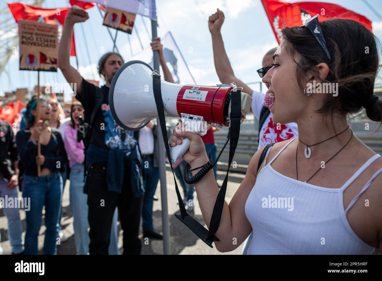 A girl shouts slogans on a megaphone during the demonstration. About 10 ...