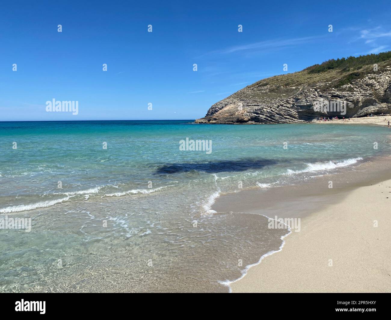 A stunning view of a tranquil beach with crystal clear and still waters ...