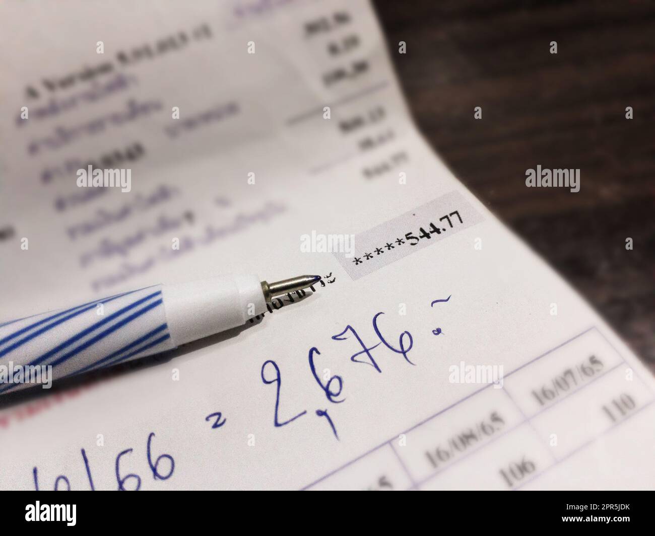 Bill and pen on dark wooden table, Bill for income and expenditure in ...