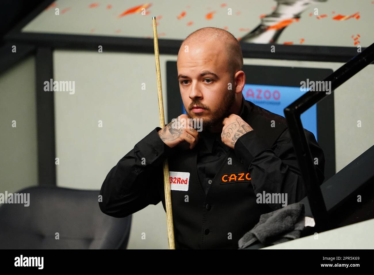 Luca Brecel in action against Ronnie O'Sullivan (not pictured) on day ...
