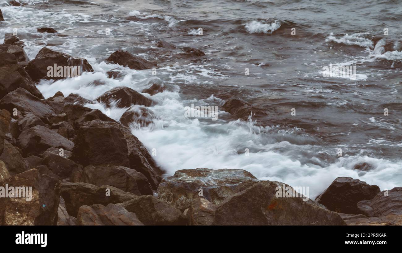 Sea waves with sky and rocks Stock Photo - Alamy