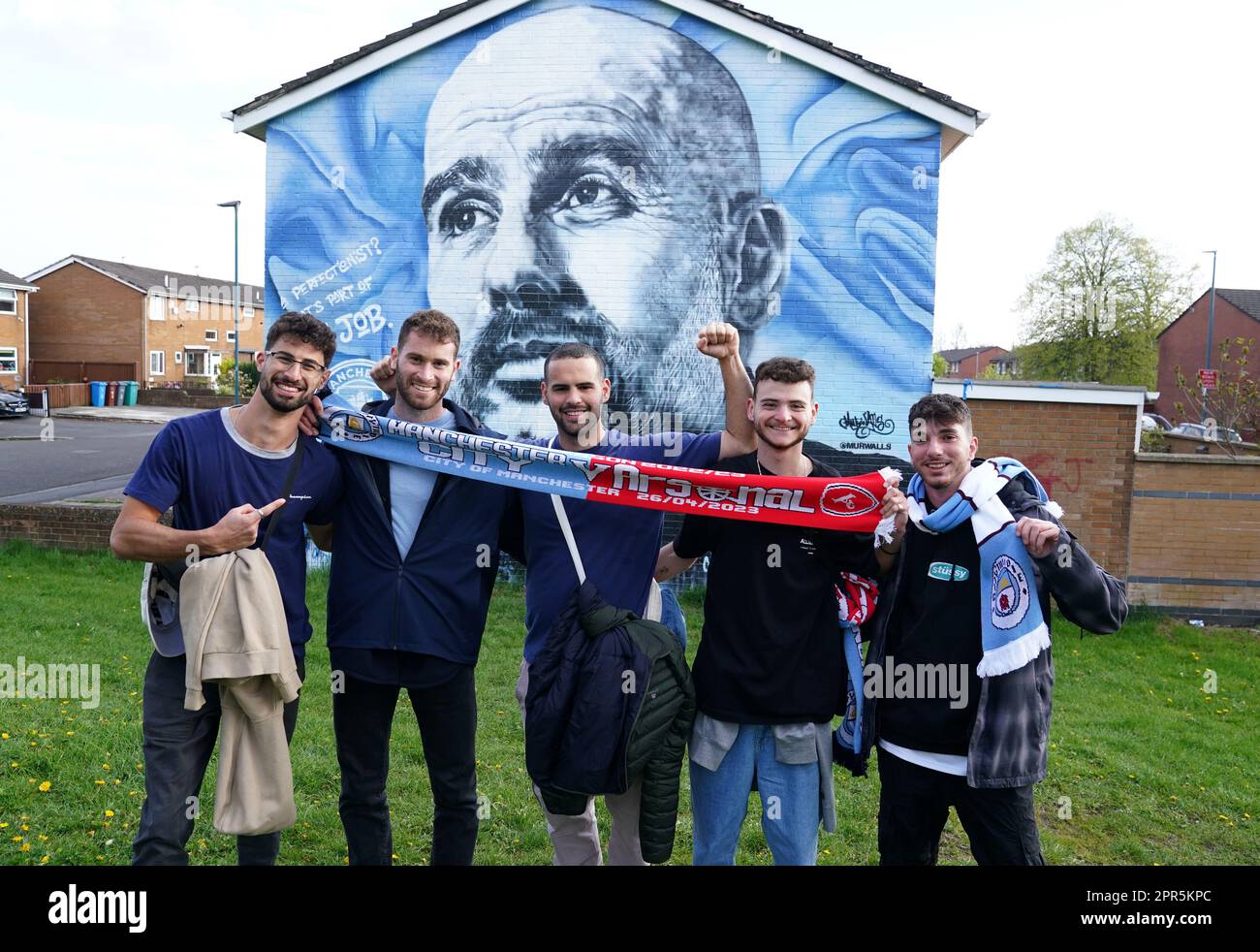 Manchester City fans pose in front of the Pep Guardiola mural near the ...
