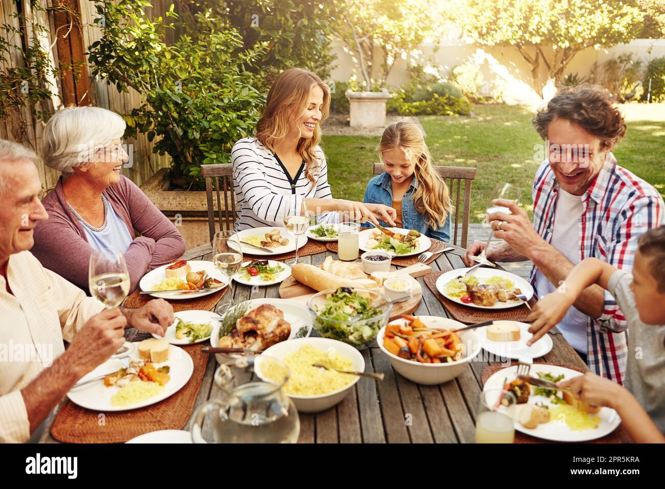 Happiness is Sunday lunch with the family. a family eating lunch ...