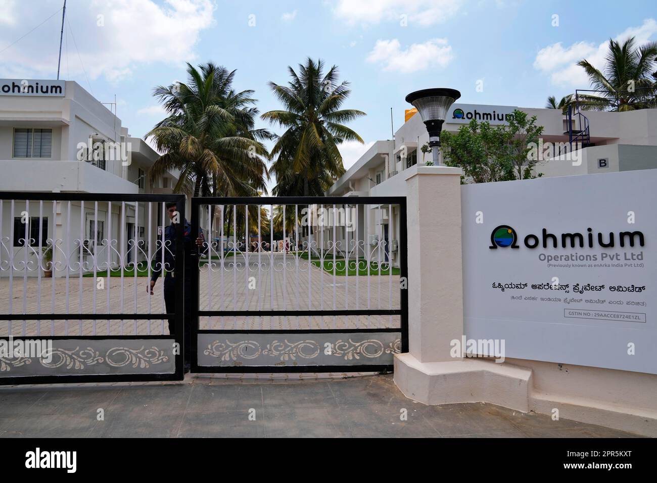 A security guard closes the main gate of the Ohmium manufacturing facility in Chikkaballapur ...