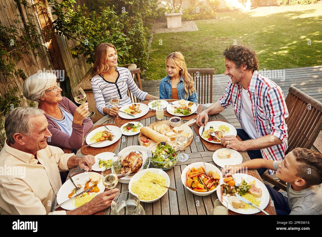 Good times and good food. a family eating lunch together outdoors Stock ...