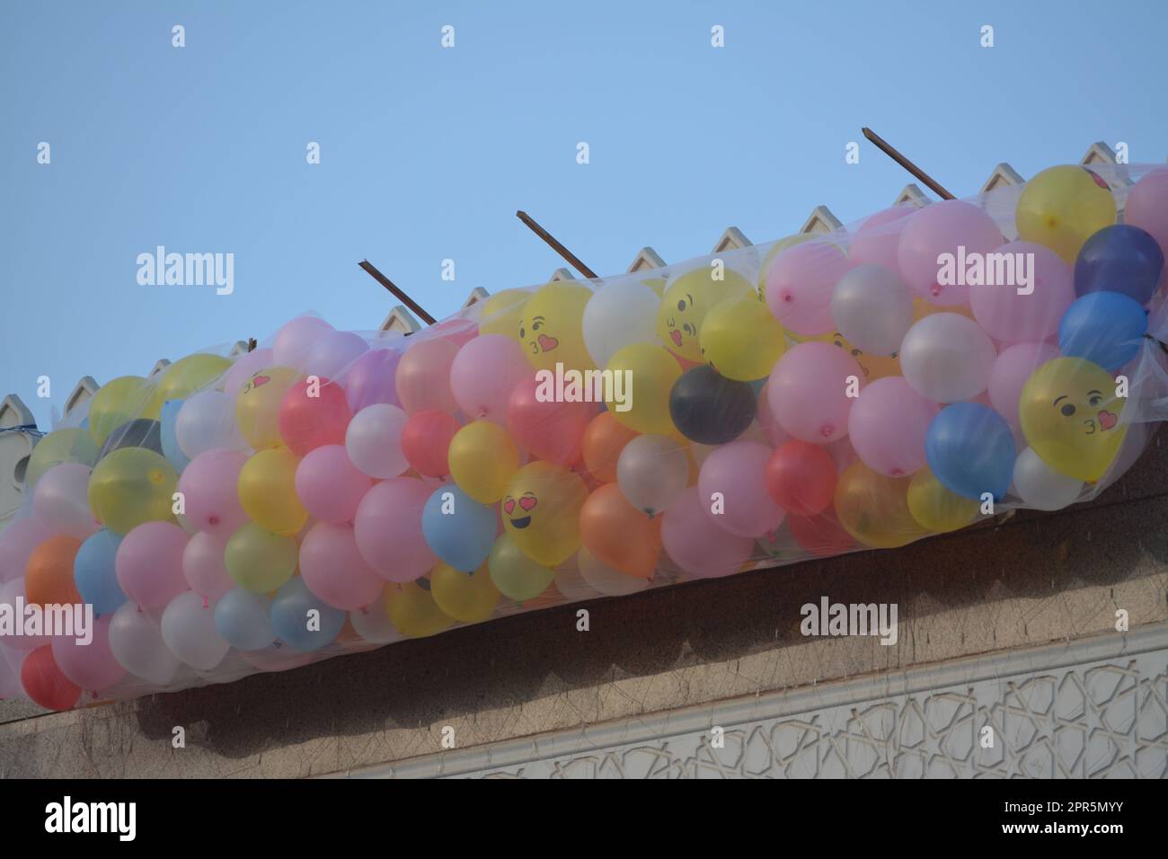 Background of festive and celebrations outside a mosque in Cairo Egypt with tens of balloons ...