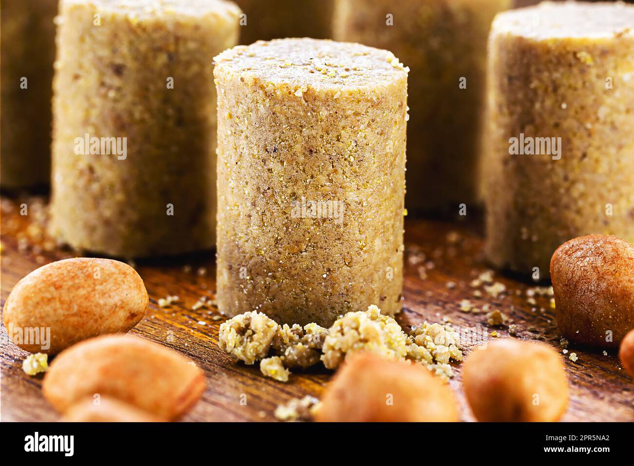 peanut jam on rustic table with pieces of peanut around. Brazilian ...