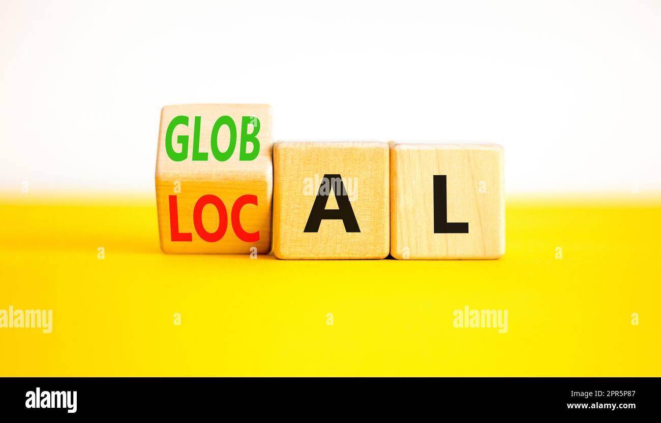 Local or global symbol. Businessman turns wooden cubes and changes the ...