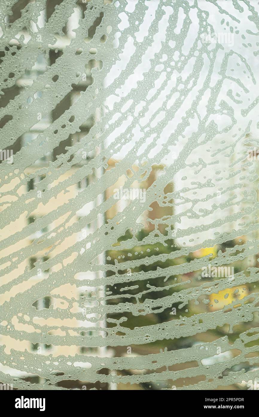 Soap foam on the window. Blurred view of abstract texture of soap ...