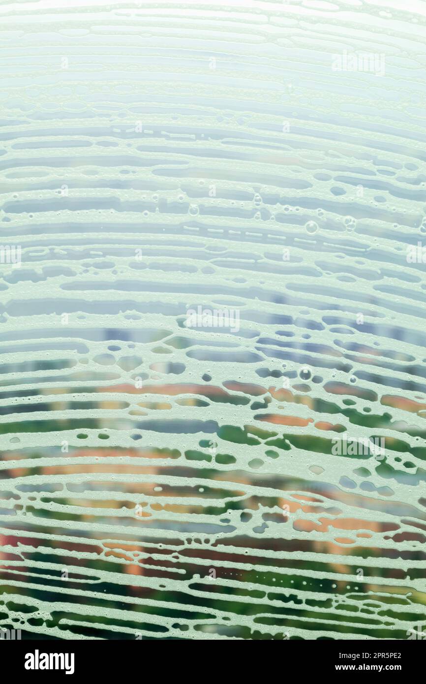 Soap foam on the window. Blurred view of abstract texture of soap ...
