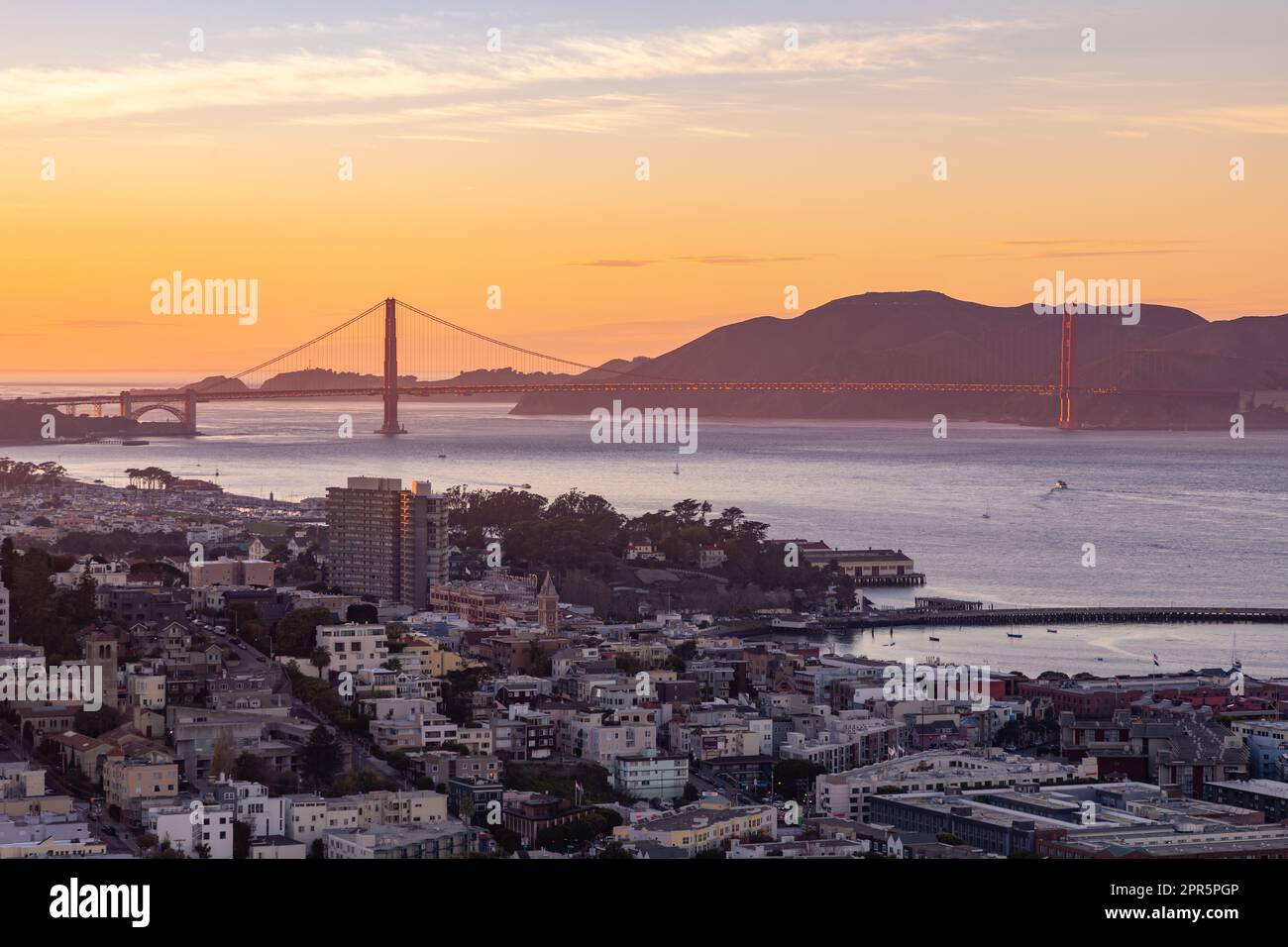 A picture of the Golden Gate Bridge at sunset as seen from the Coit ...