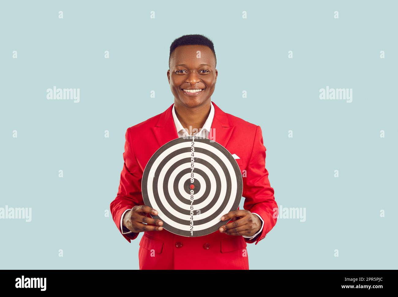 Happy African American businessman holding shooting target as symbol of ...