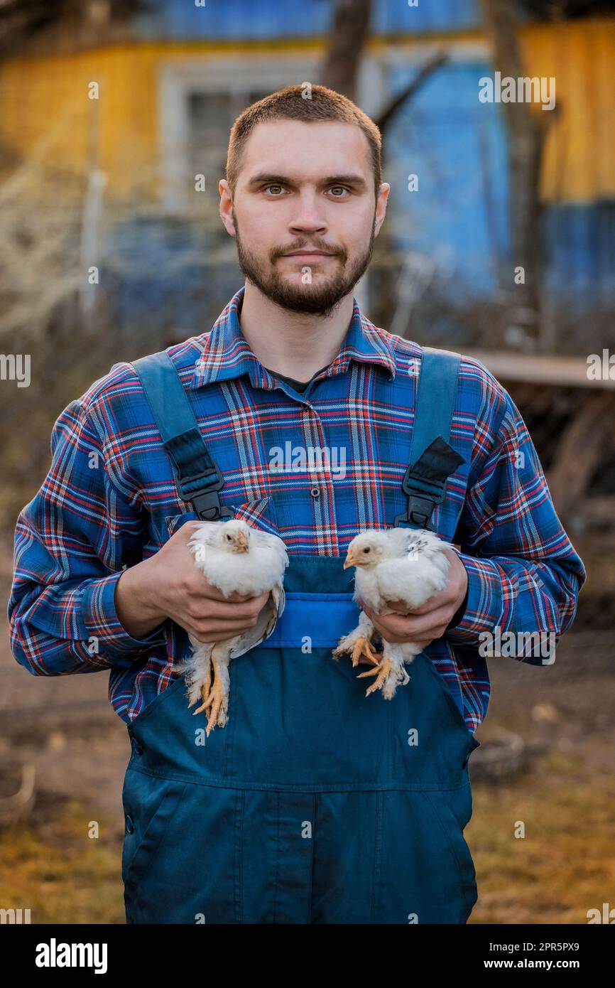 A man caucasian farmer satisfied portrait in a shirt and overalls ...