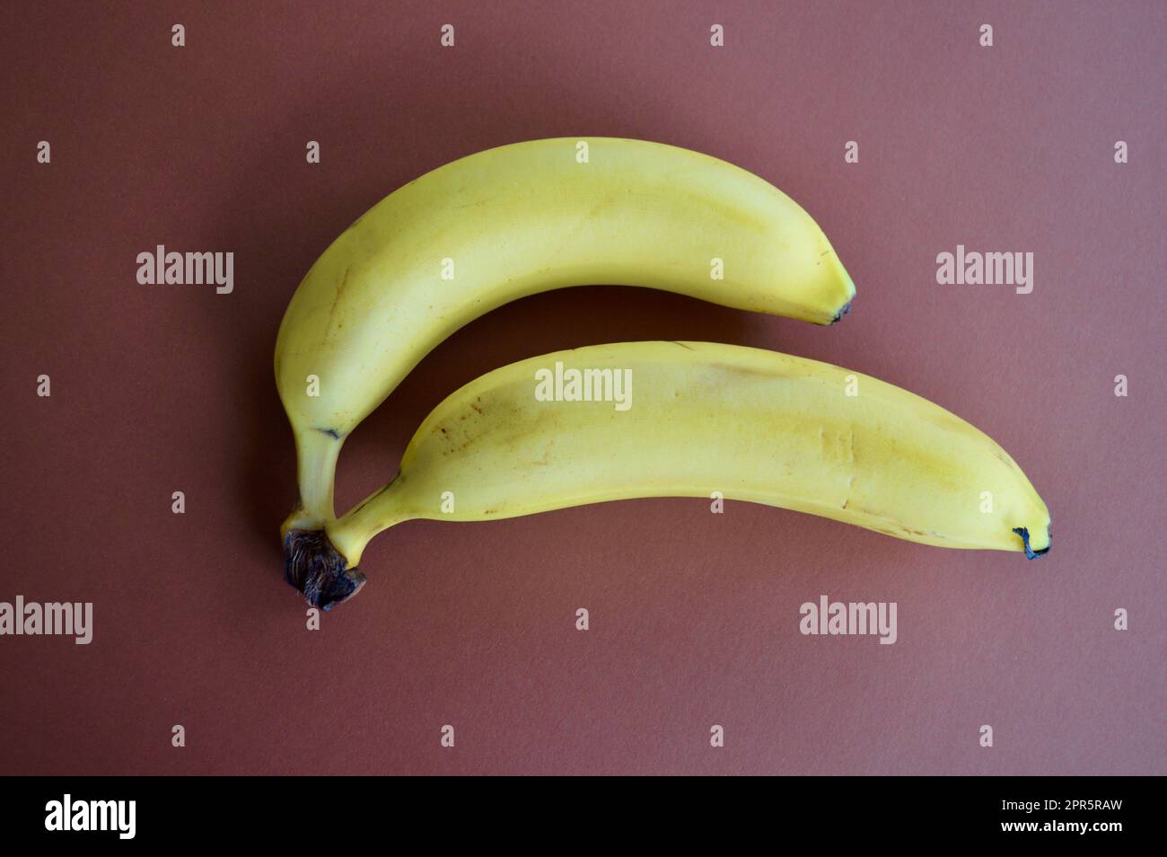 Two ripe bananas set out and ready to eat Stock Photo - Alamy
