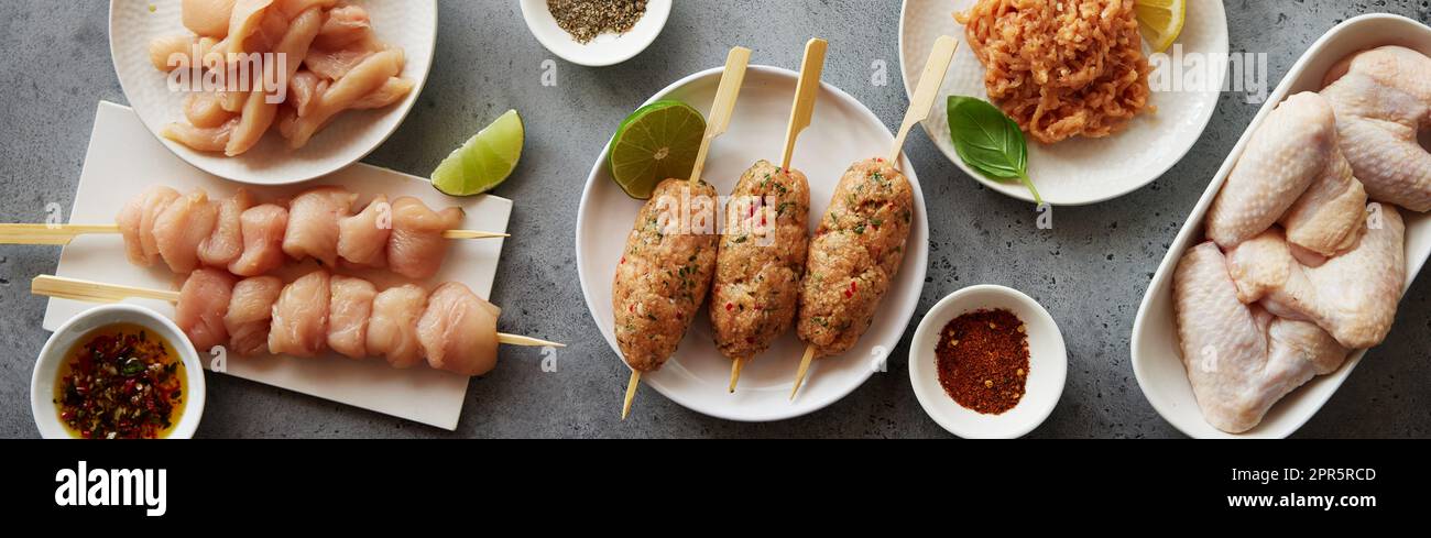 Various uncooked chicken meat on gray surface Stock Photo - Alamy
