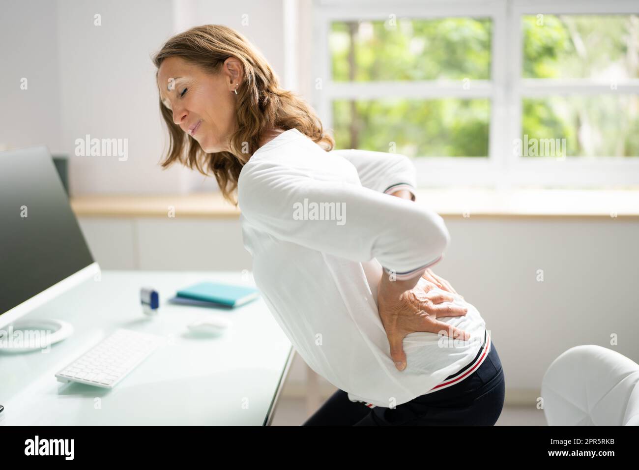 Backache woman sofa hi-res stock photography and images - Alamy