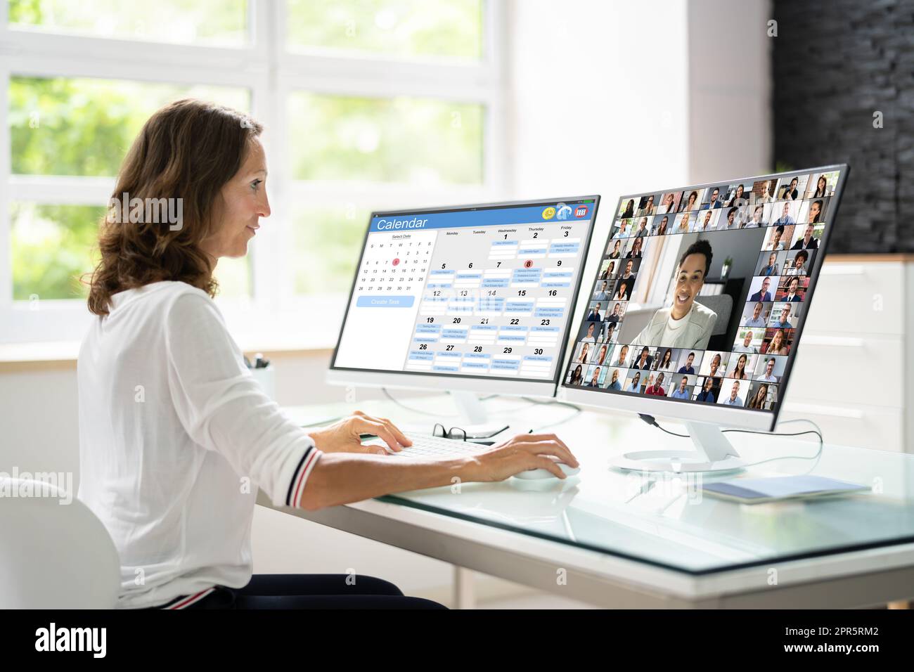 Virtual Conference Agenda On Multiple Computers Stock Photo - Alamy