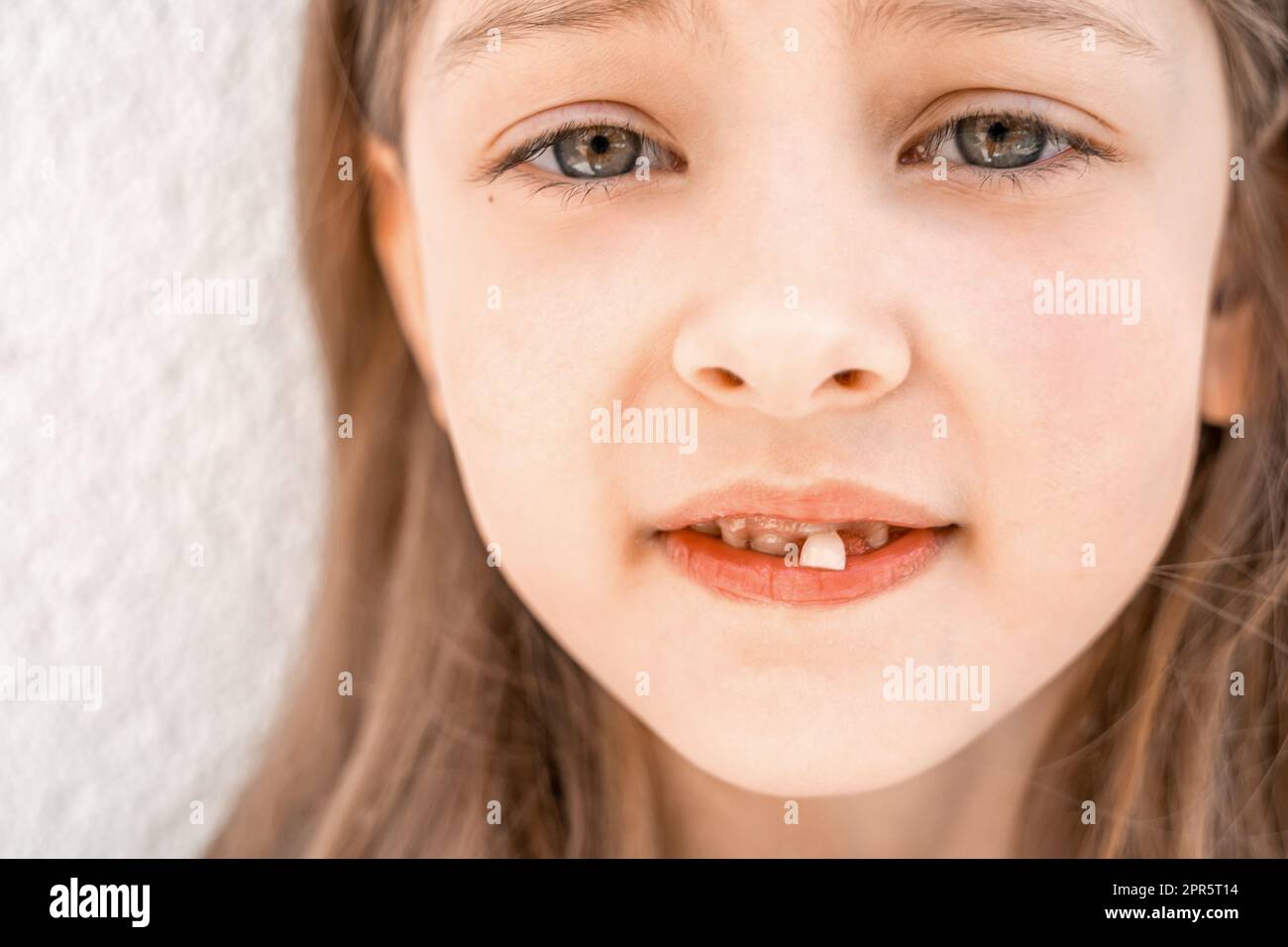 Charming smiling little girl kid with opened mouth shows staggering ...