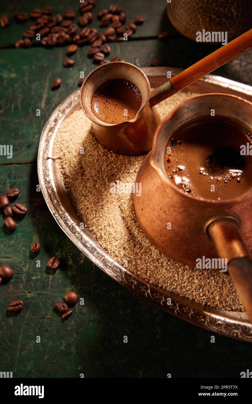 Traditional oriental coffee on sand Stock Photo - Alamy