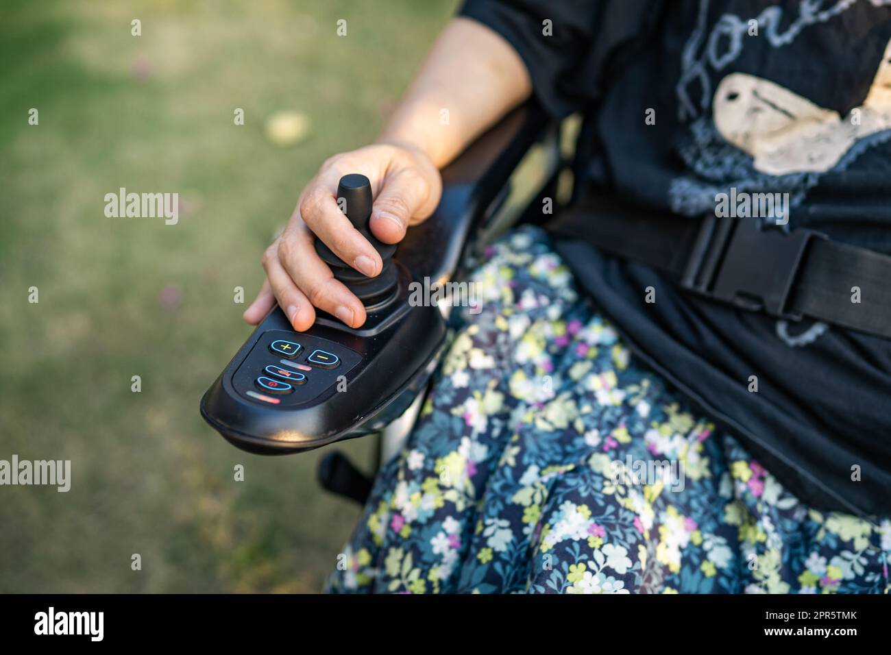 Asian lady woman patient on electric wheelchair with joystick and ...