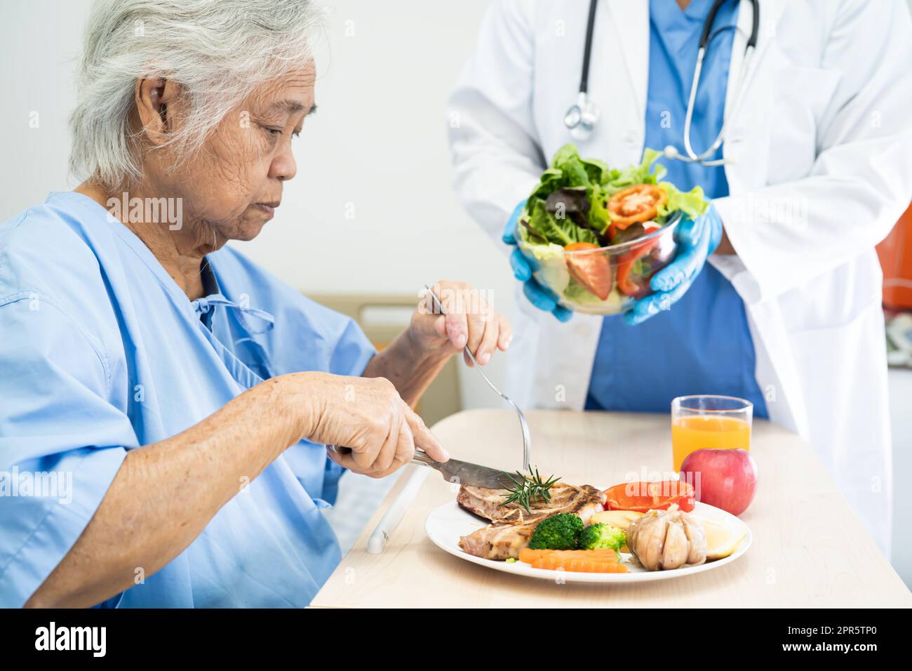 Asian senior or elderly old lady woman patient eating breakfast and ...