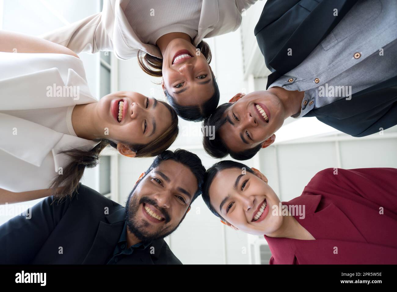 Portrait closeup bottom view happy faces of employees team standing in ...