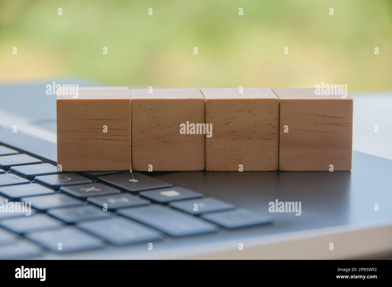 Blank wooden blocks on top of a laptop ready for new ideas. Copy space ...