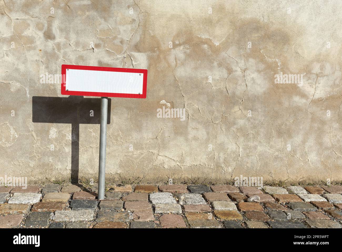 empty white sign with text space at the roadside in front of a house ...