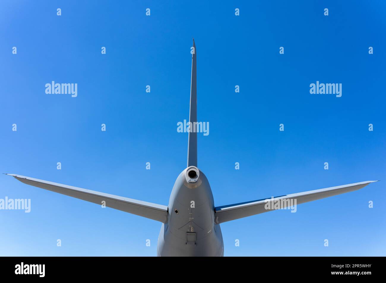 The empennage of the passenger aircraft against background of blue sky ...