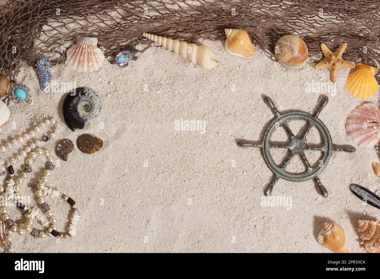 Captains Wheel With Fishing Net and Sea Shells on Sand Nautical Theme ...