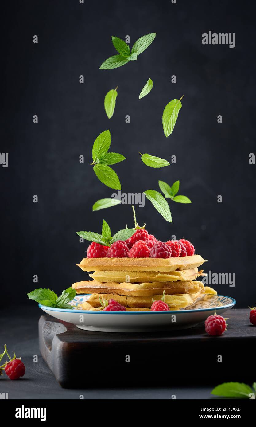 Stack of baked Belgian waffles with ripe red raspberry Stock Photo - Alamy