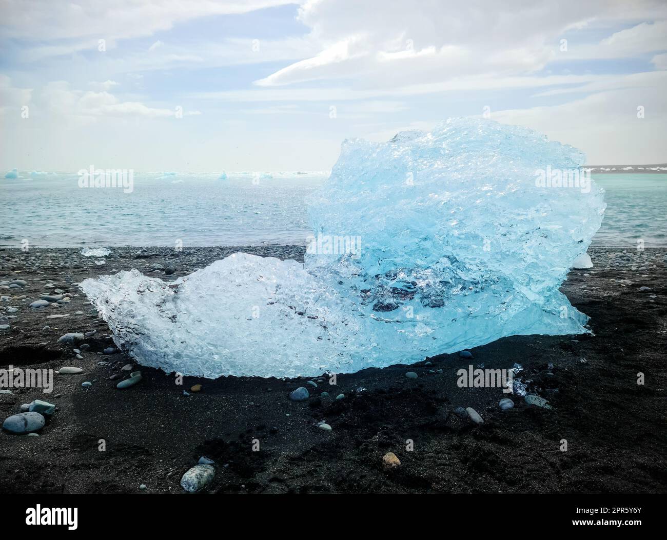 Diamond Beach in Iceland with blue icebergs melting on black sand and ...