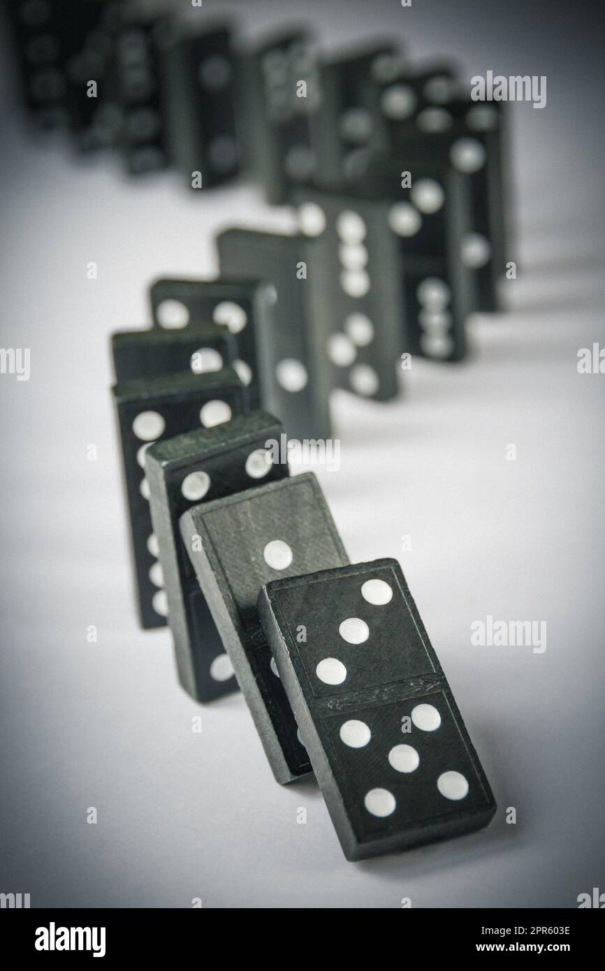 Black dominoes chain on table background Stock Photo - Alamy