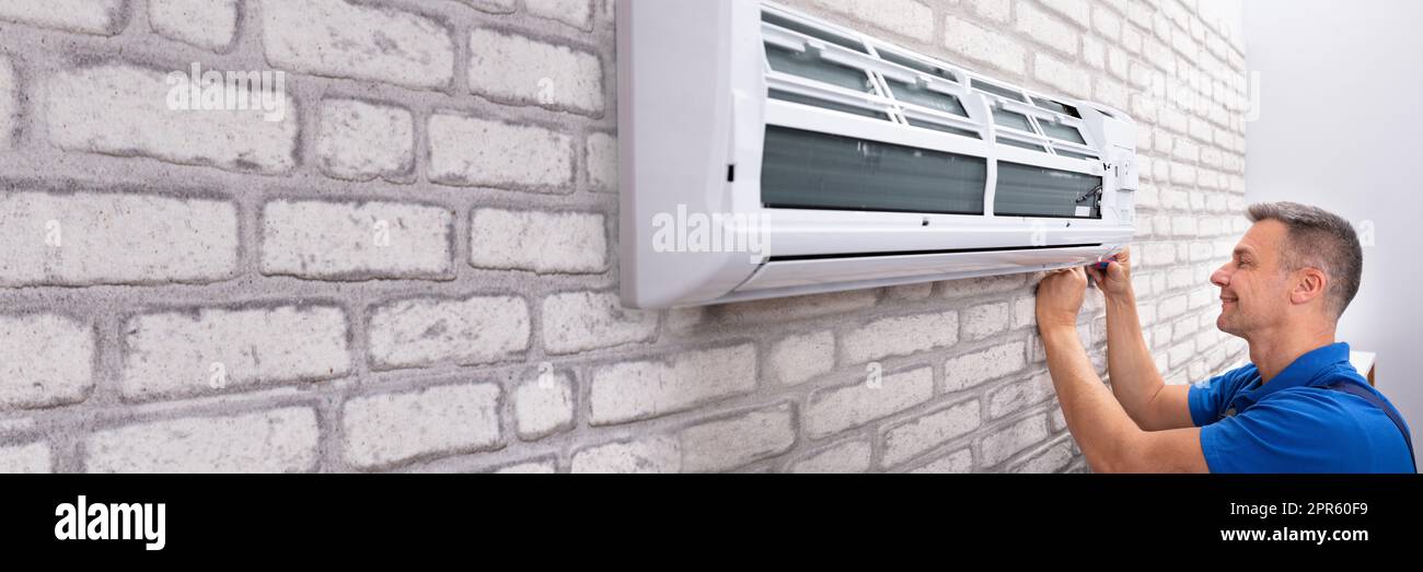 Technician Fixing Air Conditioner Stock Photo - Alamy
