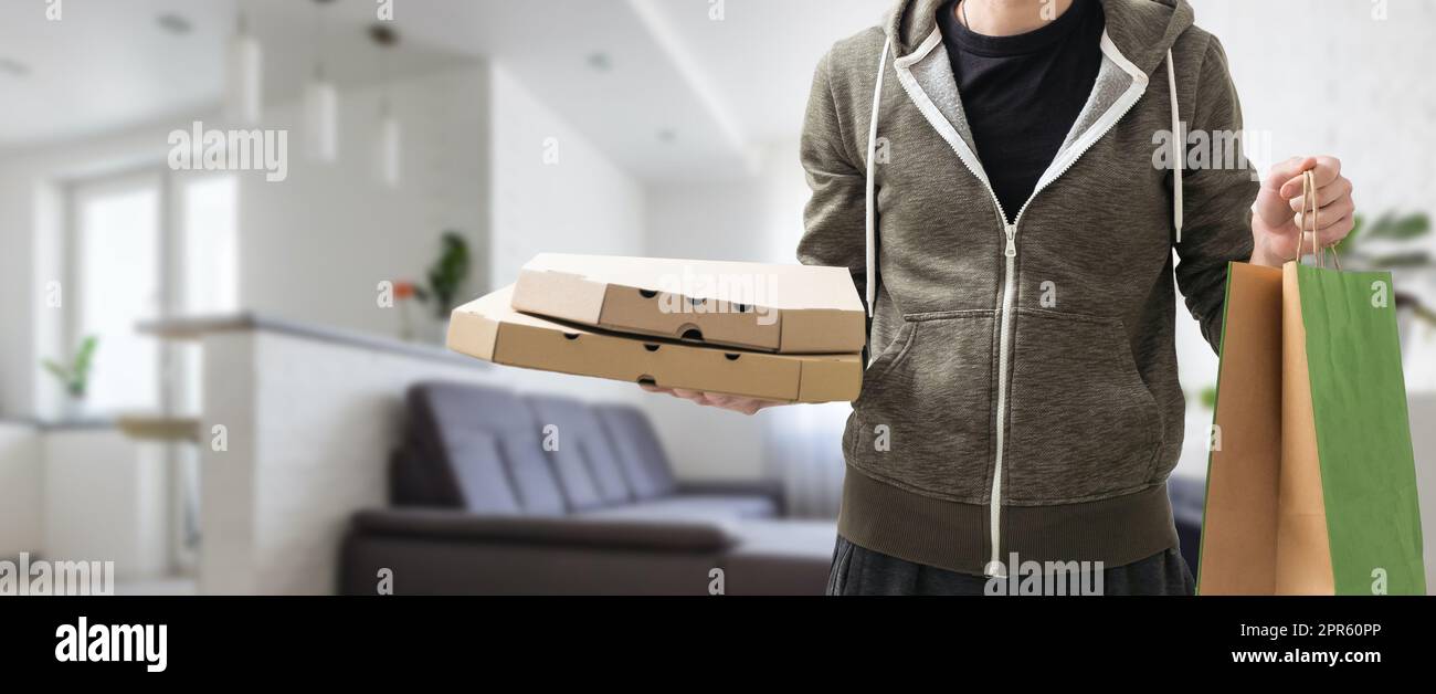 Courier holding paper bags with food, space for text. Delivery service ...