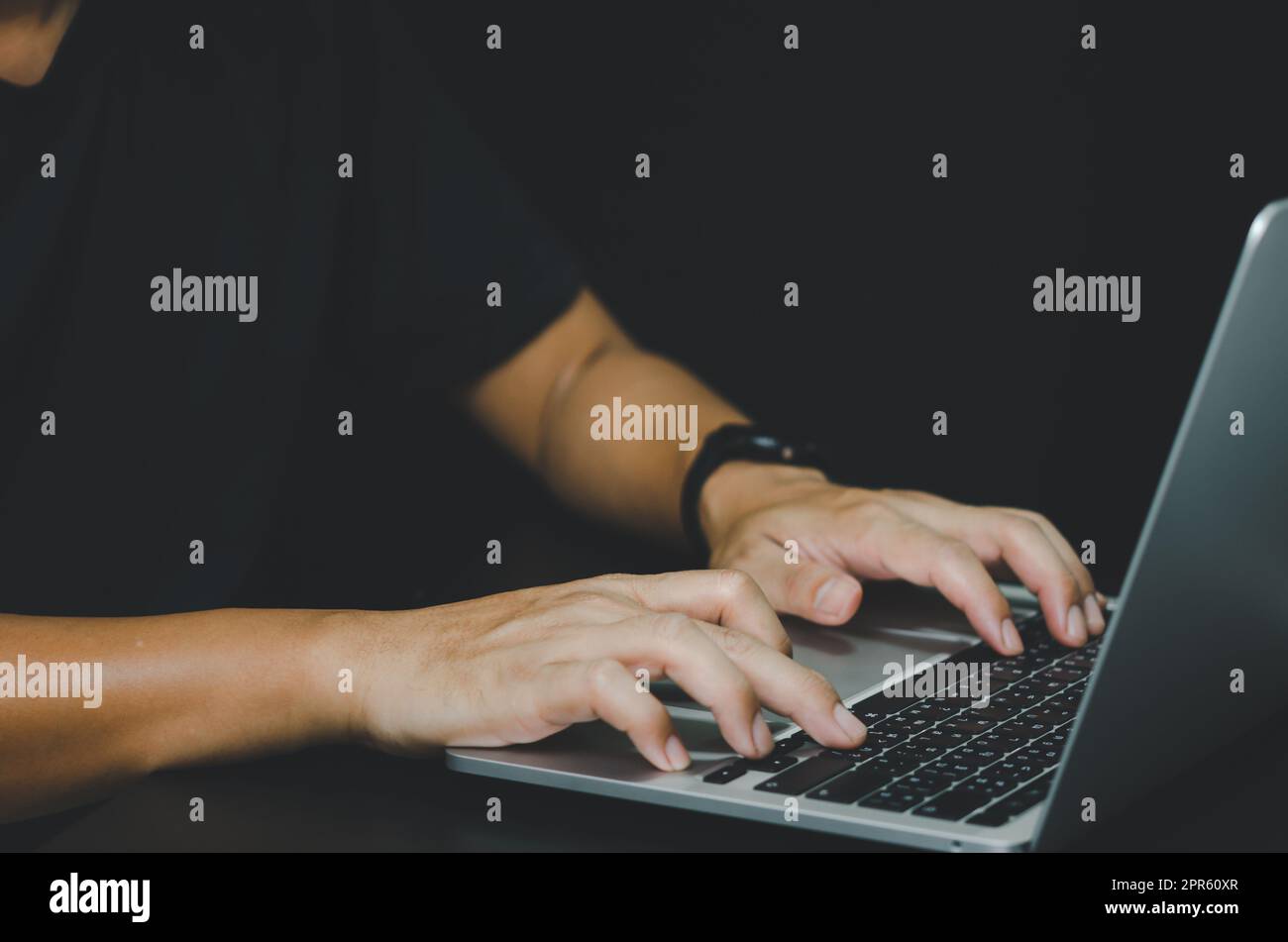 Person using in hand keyboard computer laptop on black background Stock ...