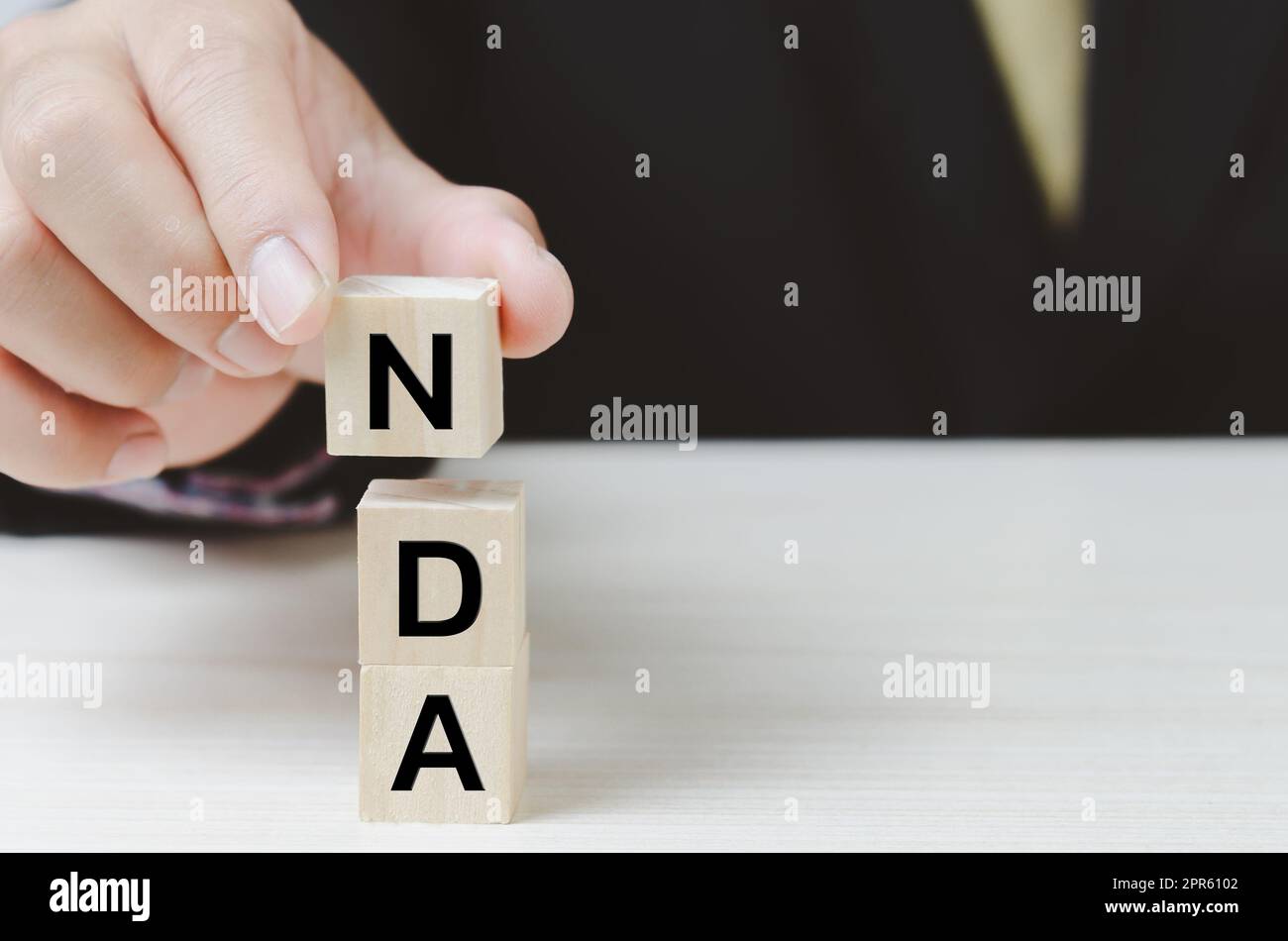 Wooden cubes with NDA Non disclosure Agreement symbol on background and ...