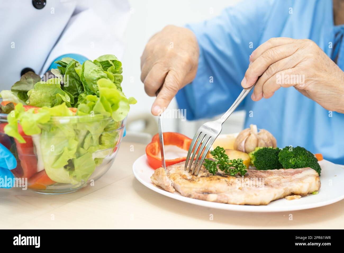 Man eating on hospital bed hi-res stock photography and images - Alamy