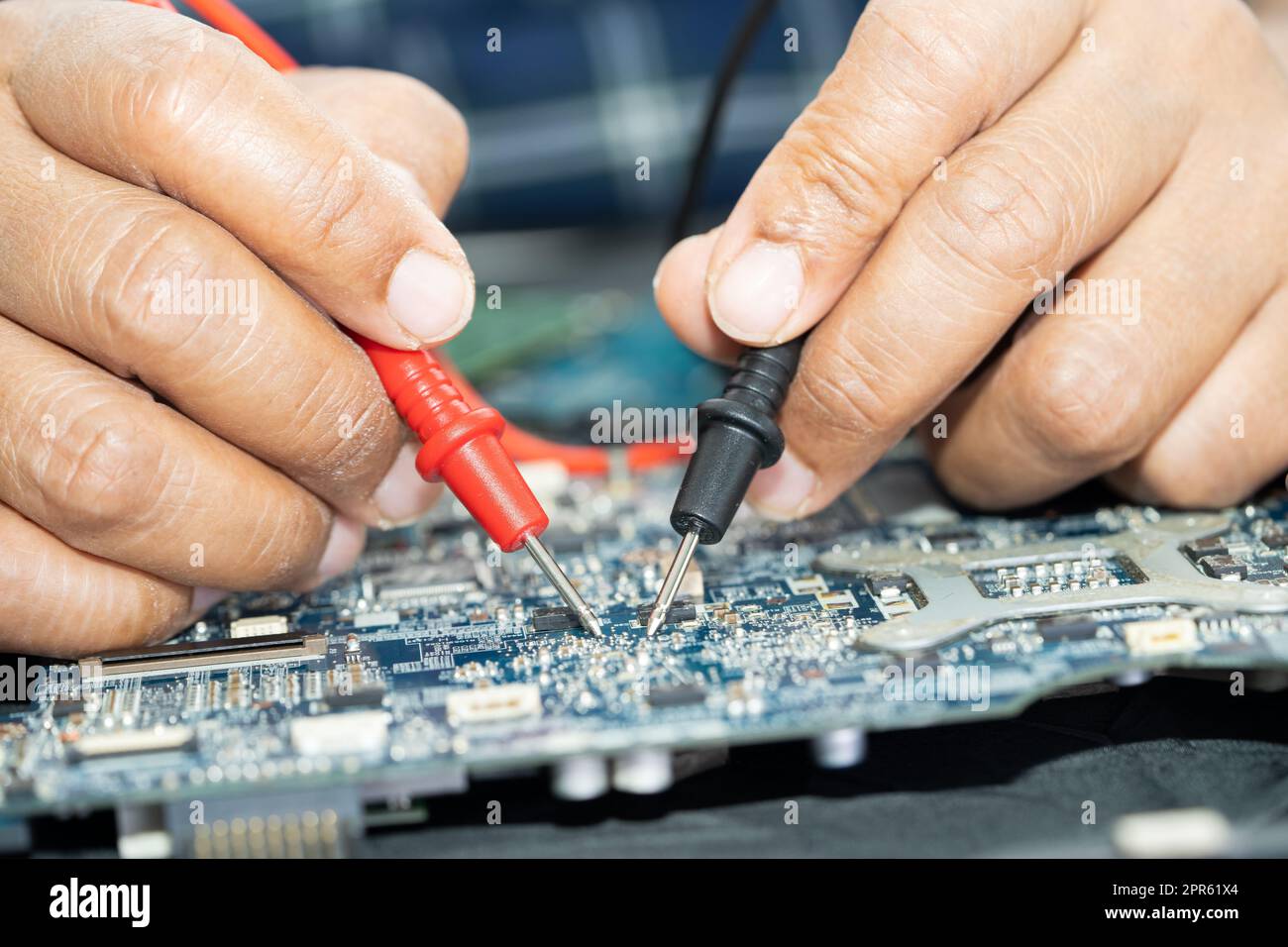 Technician repairing inside of mobile phone. Integrated Circuit. the ...