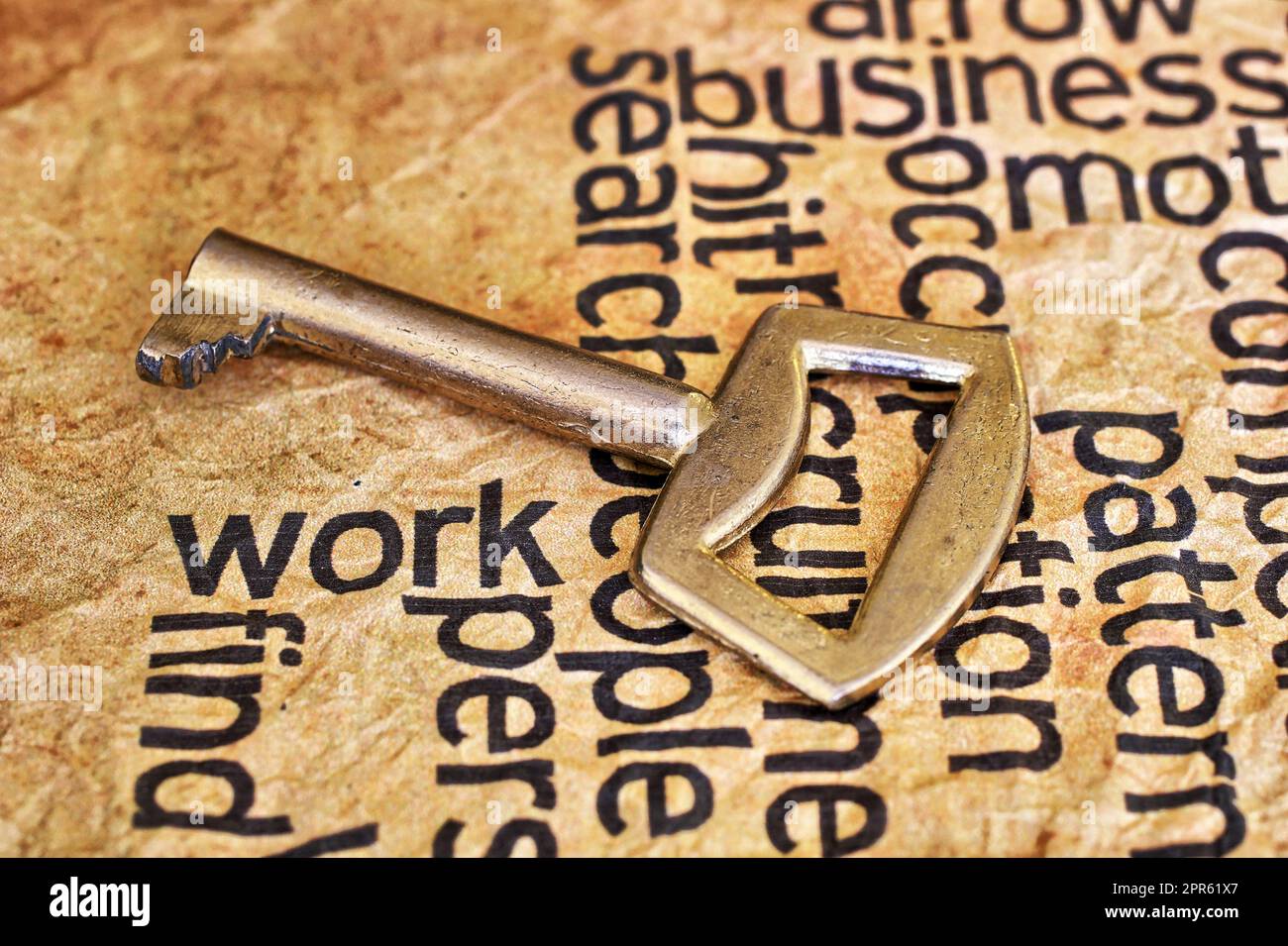 Golden key on work text Stock Photo - Alamy