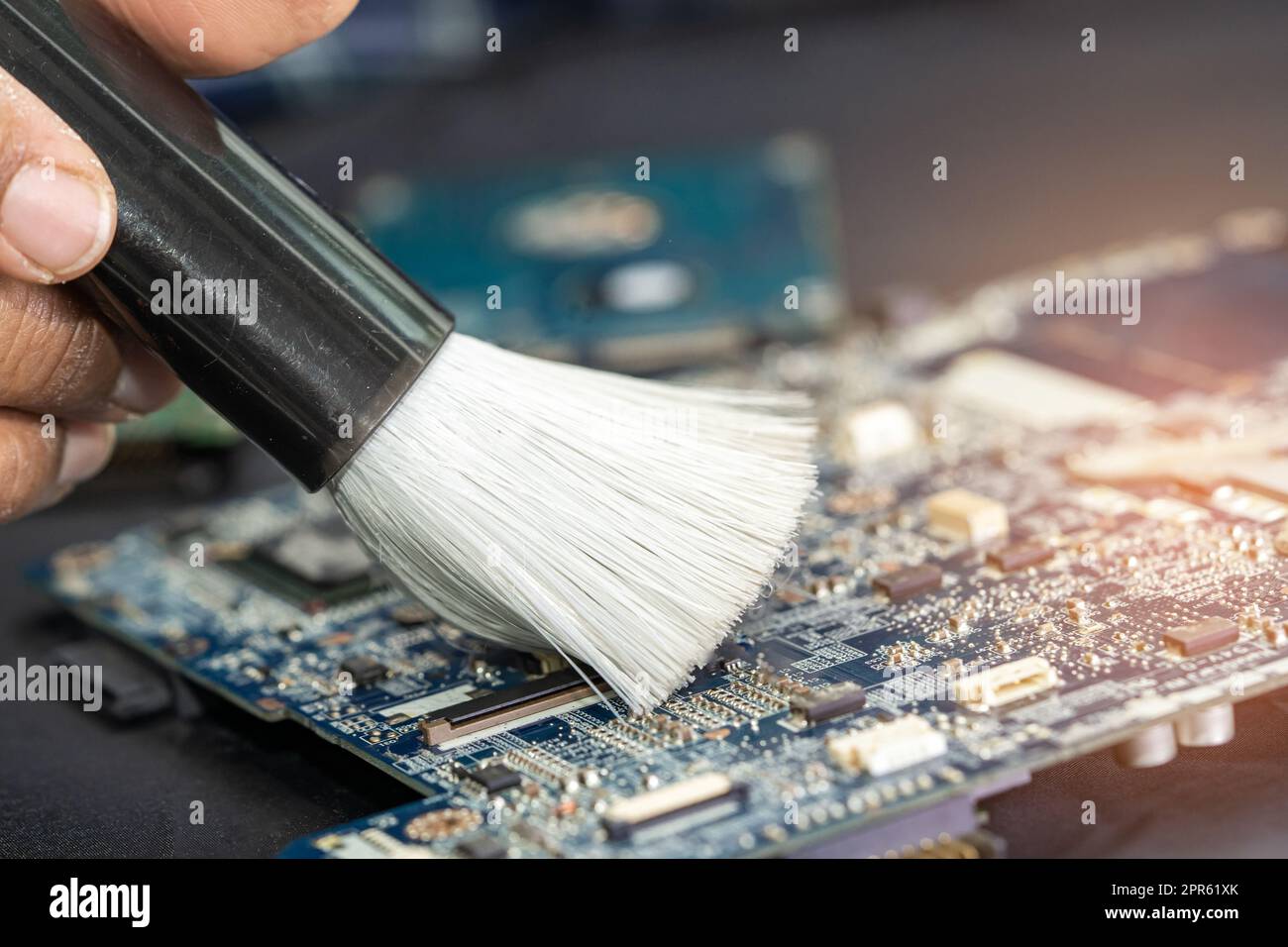 Technician use brush and air blower ball to clean dust in circuit board ...