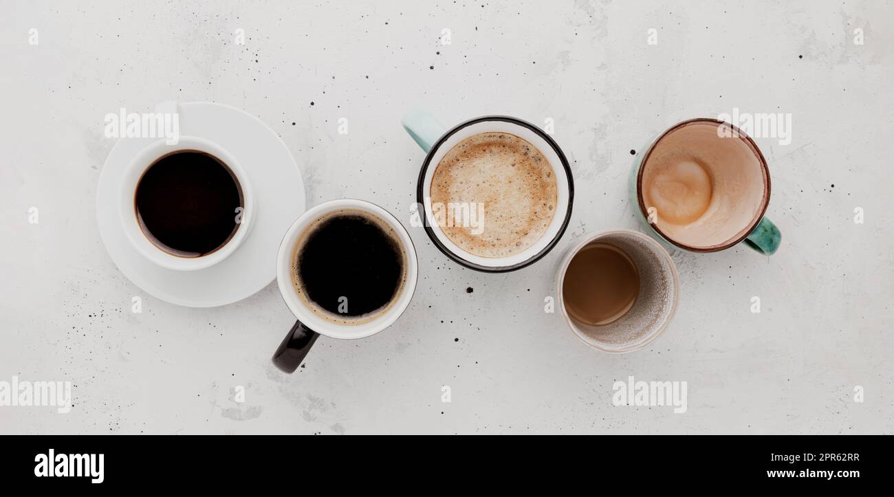 Top view on flat lay with many different full and empty coffee cups on ...