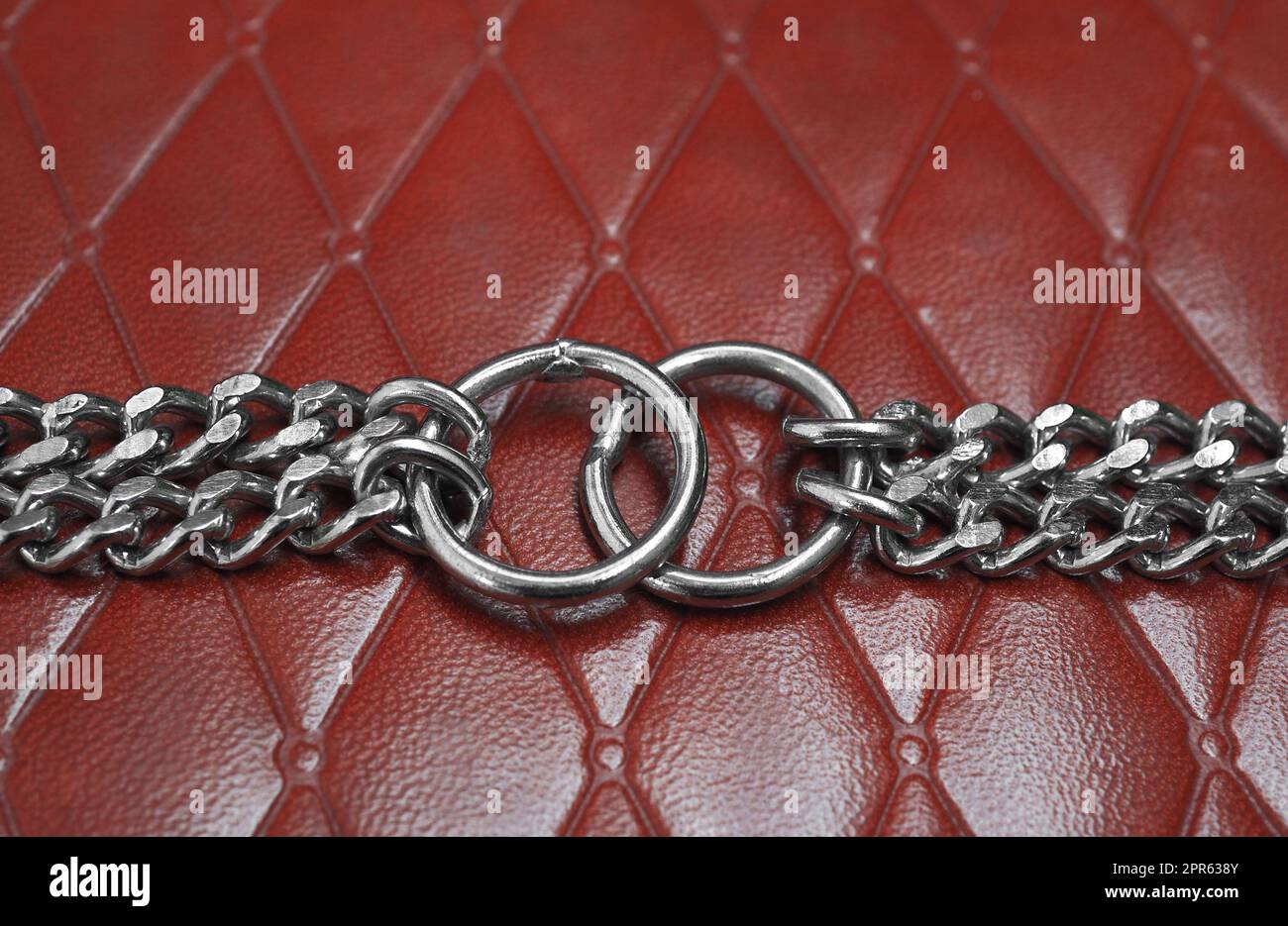 Metal chain with ring on leather Stock Photo - Alamy