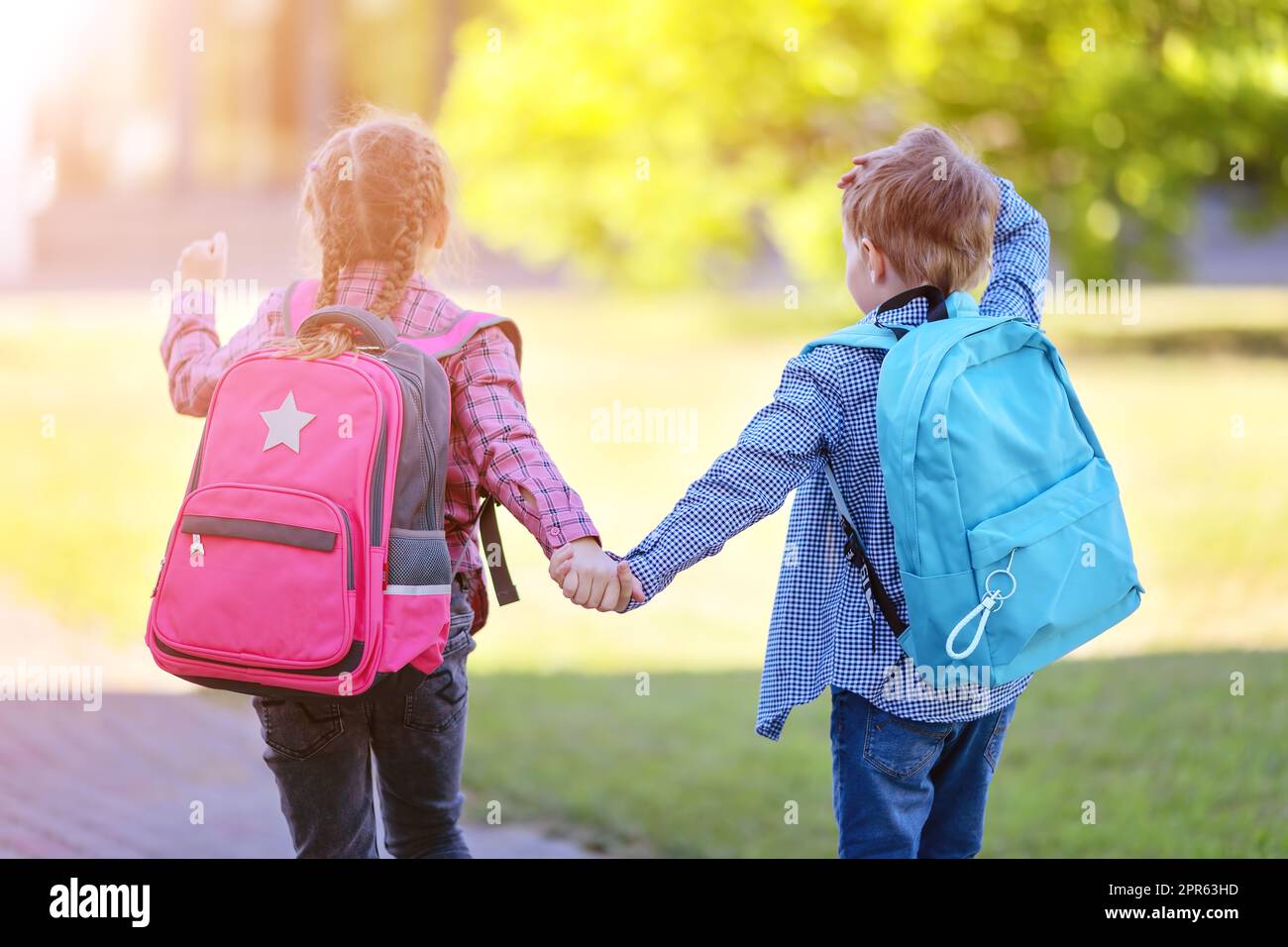 Girl and boy going to the school holding hands to study at it Stock ...