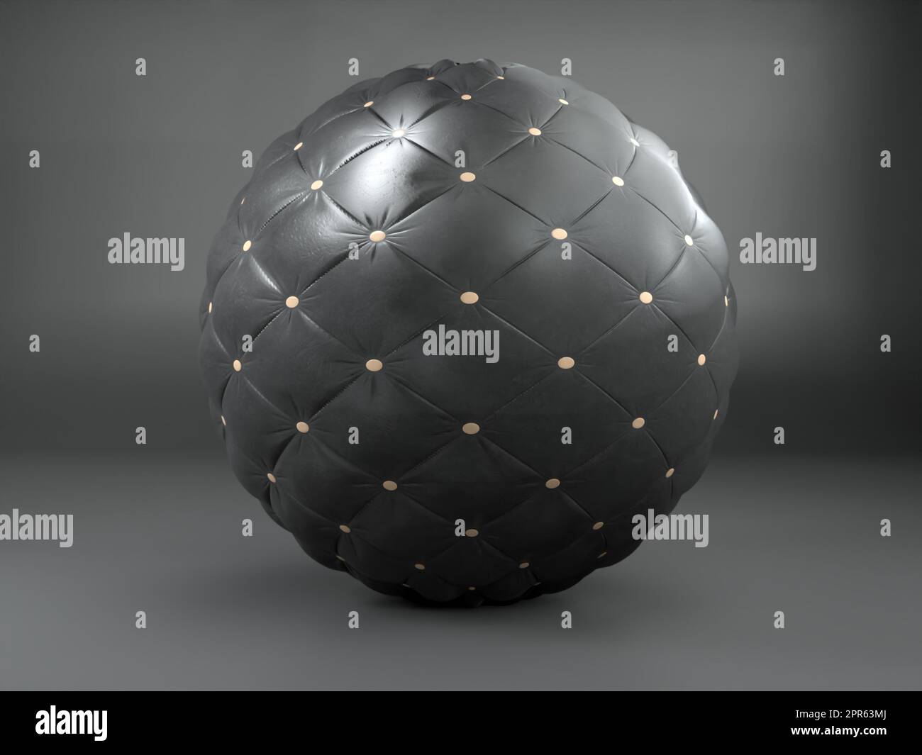 Black leather sphere bradded with golden hobnails on gray background ...