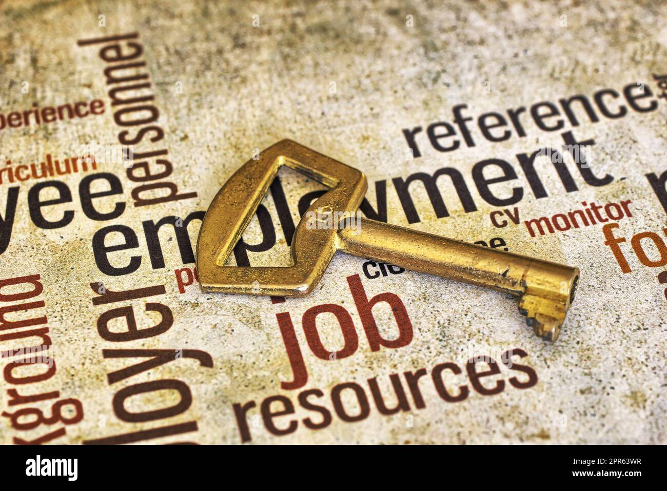 Golden key on job text Stock Photo - Alamy